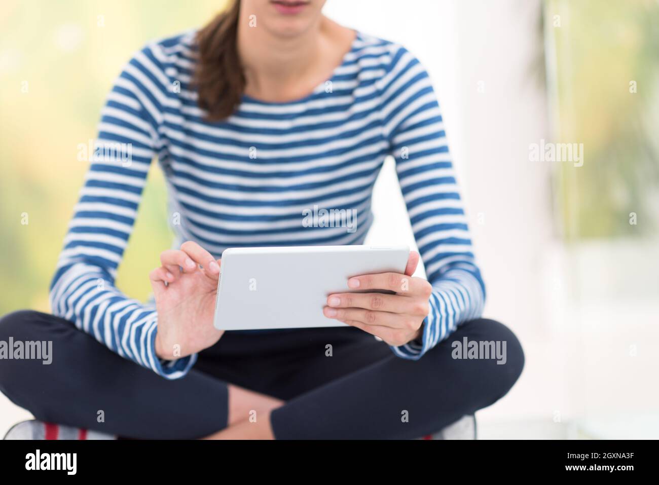 beautiful young women using tablet computer on the floor at home Stock ...