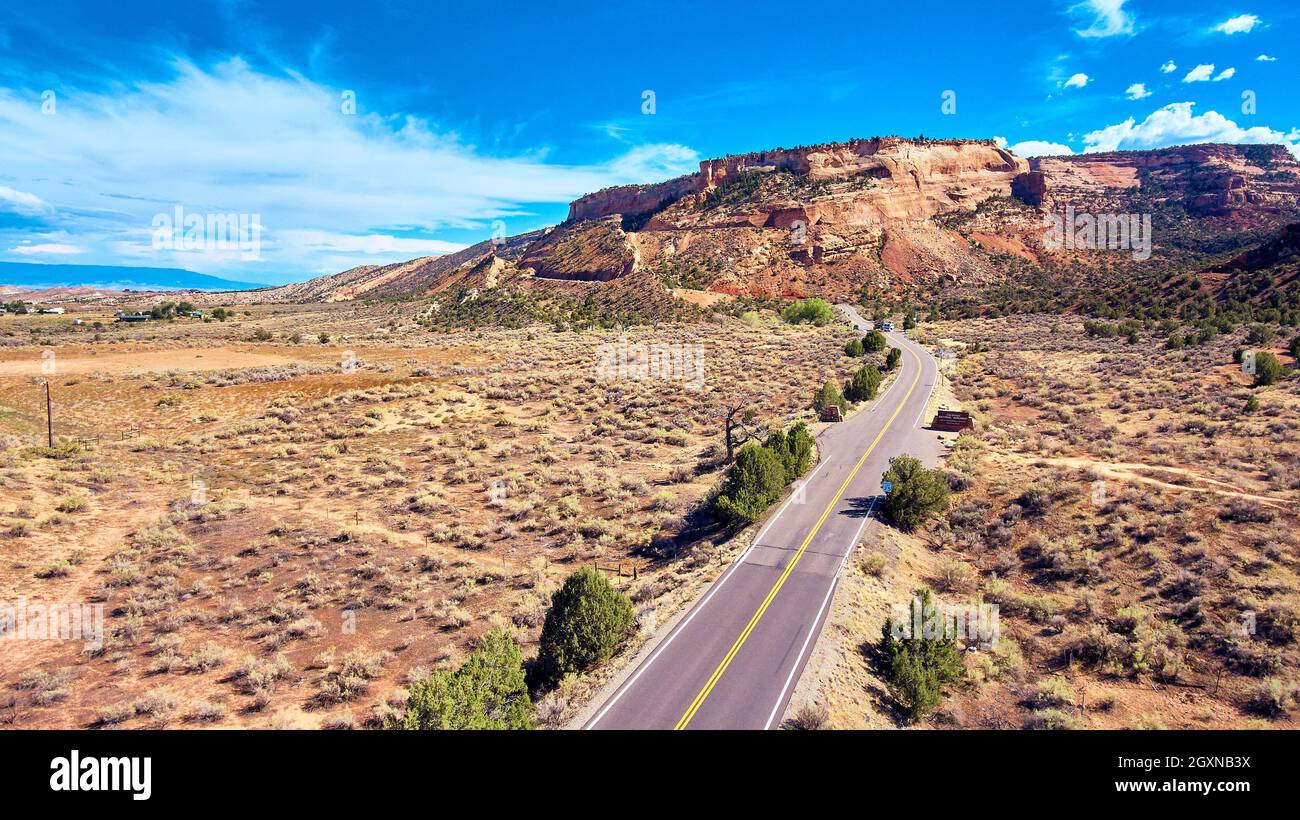 Open road across desert into mountains Stock Photo - Alamy