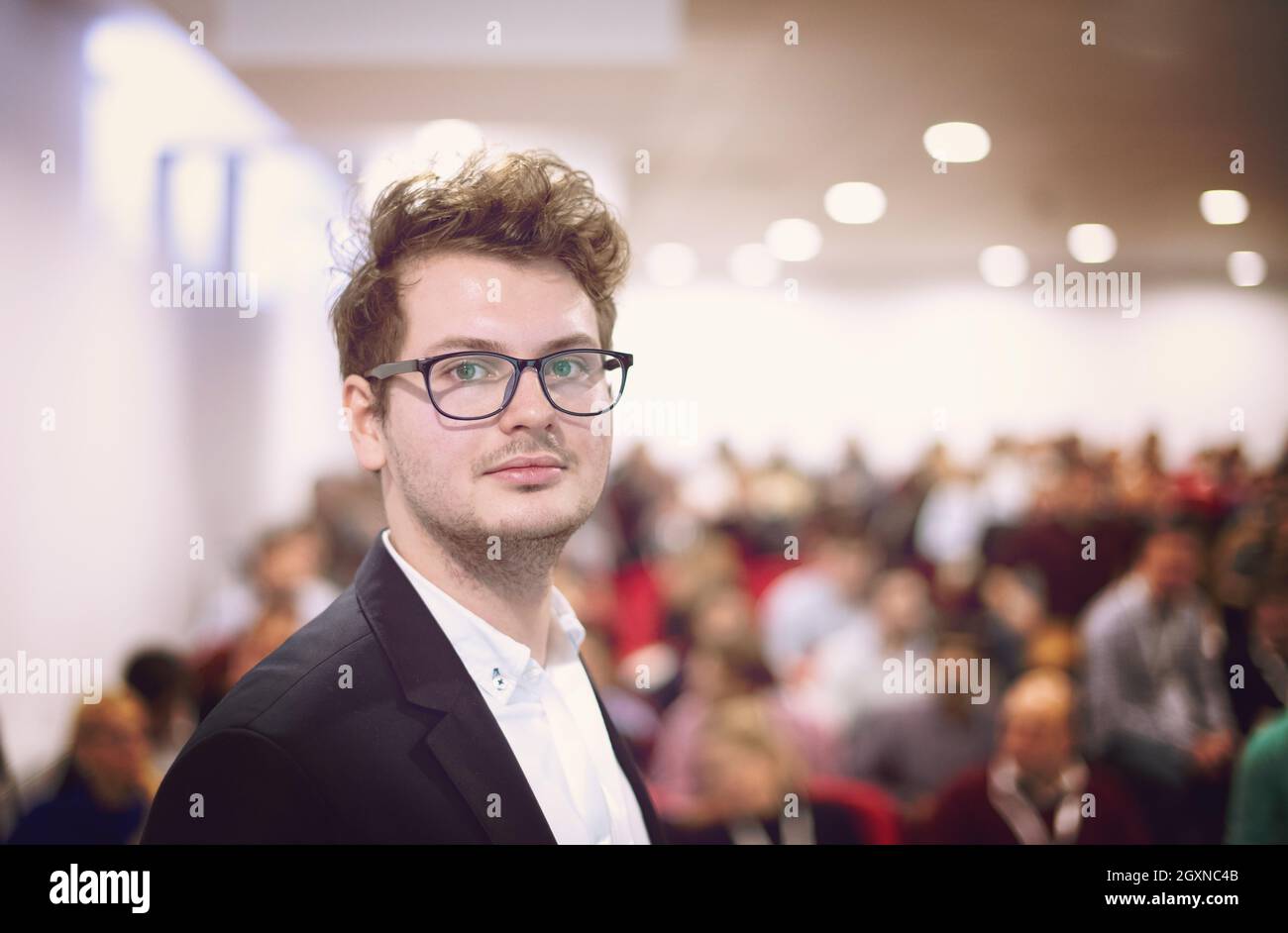 young businessman at business conference room with public giving ...
