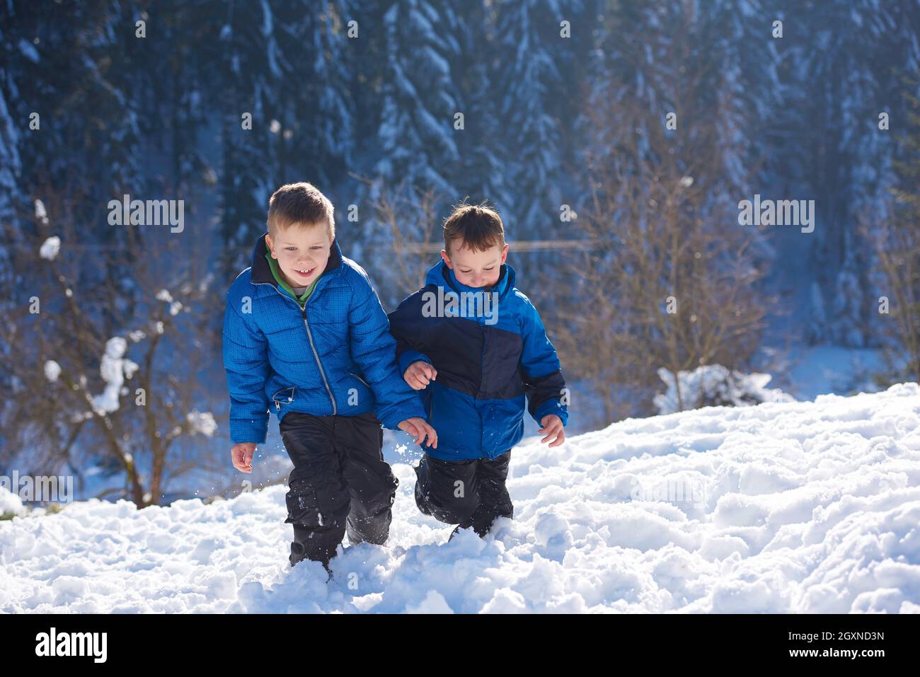 happy kids playing in fresh snow at beautiful sunny winter day Stock ...