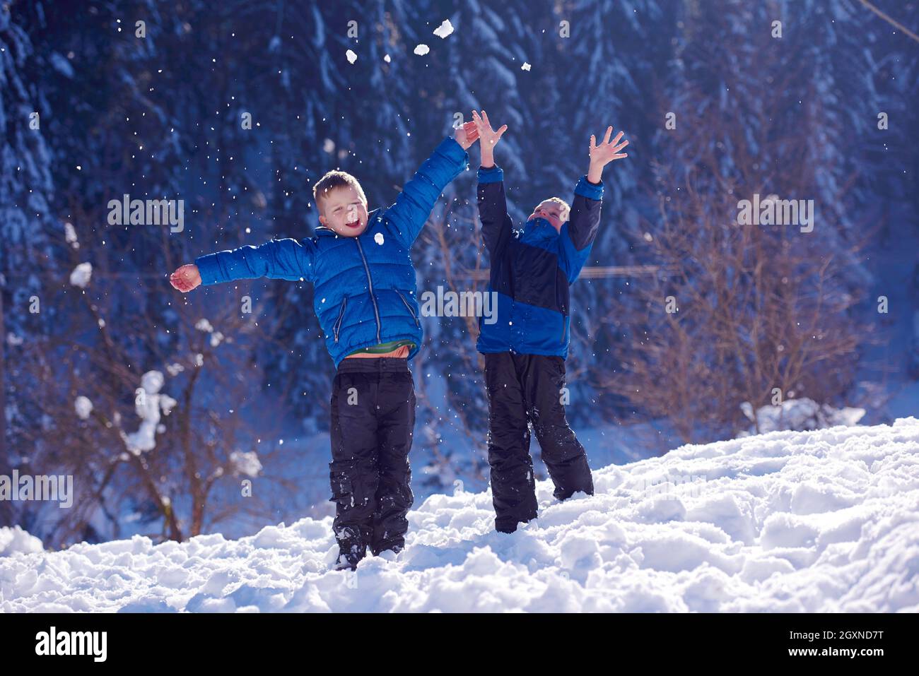 happy kids playing in fresh snow at beautiful sunny winter day Stock ...