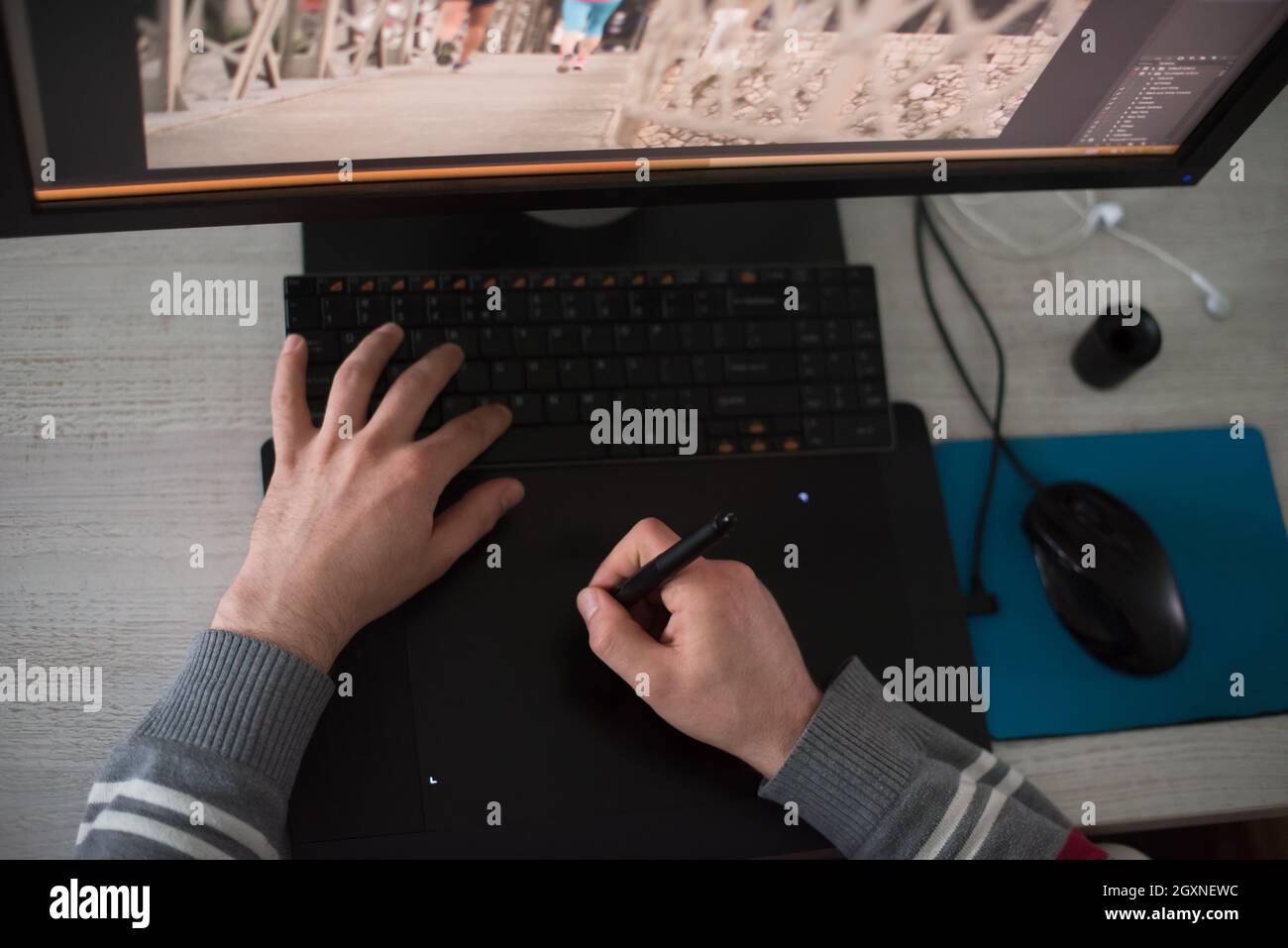 Young graphic designer working on a digital tablet and a computer top ...