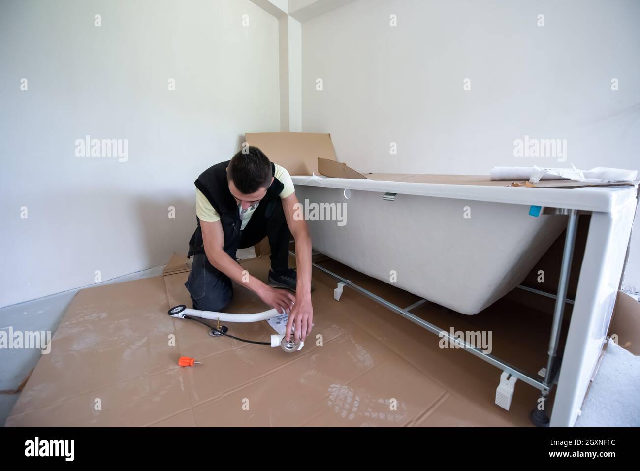 professional plumber working in a bathroom, plumbing repair service ...