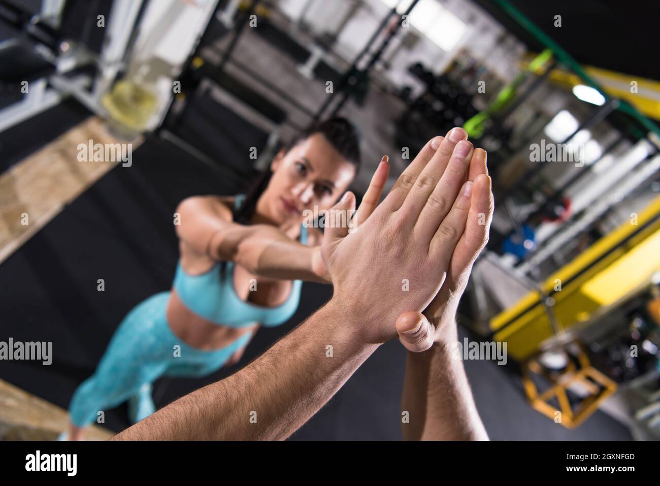 group of young athletes making high five after hard exercise at cross ...