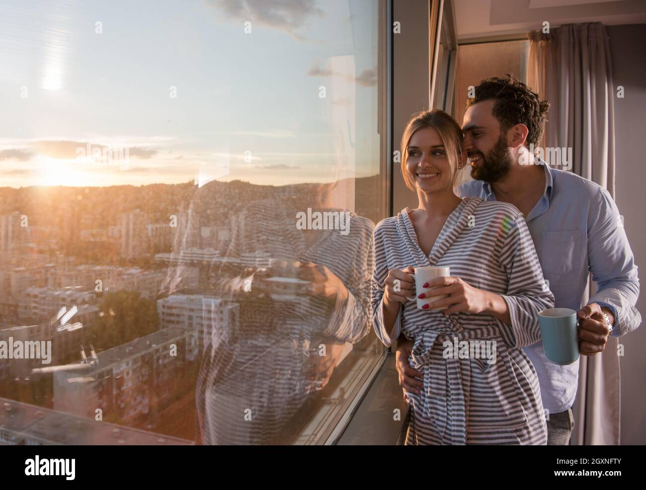 romantic happy young couple enjoying evening coffee and beautiful ...