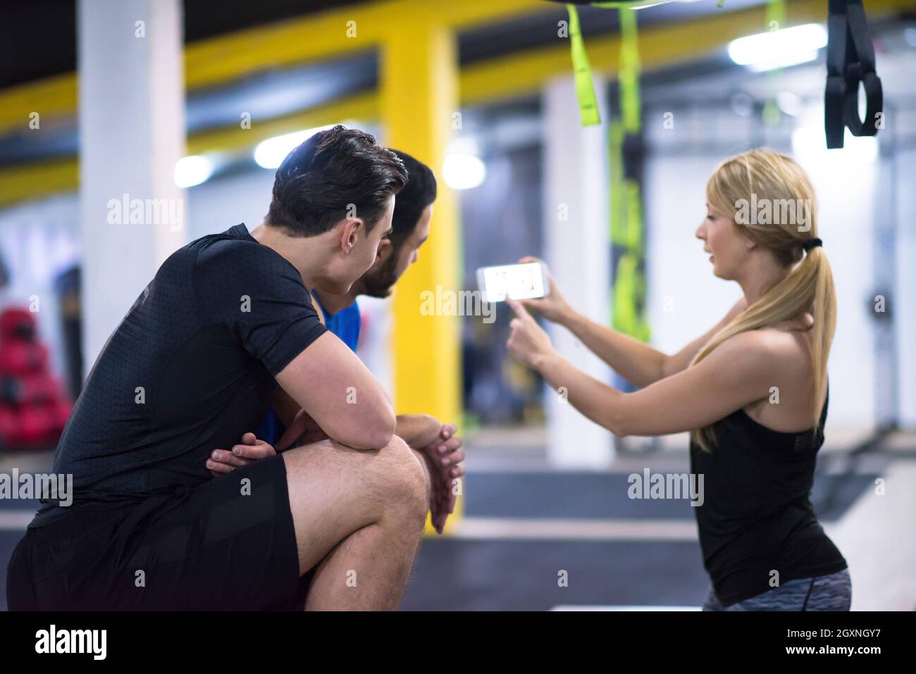 group of young healthy athletic people training jumping on fit box at ...