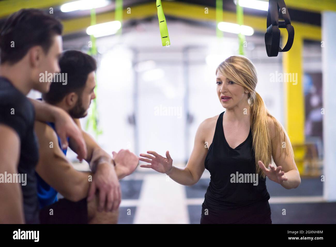group of young healthy athletic people training jumping on fit box at ...