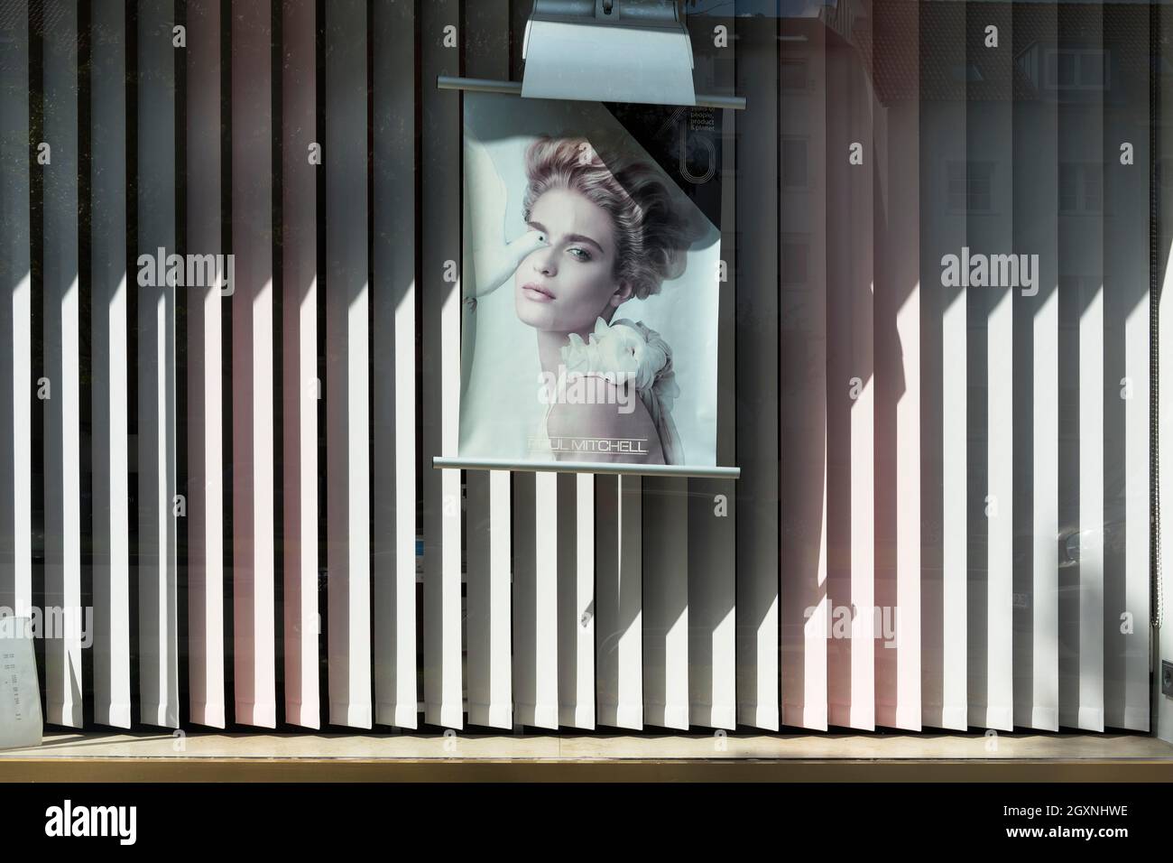Advertising poster in the shop window of a hairdressing salon ...
