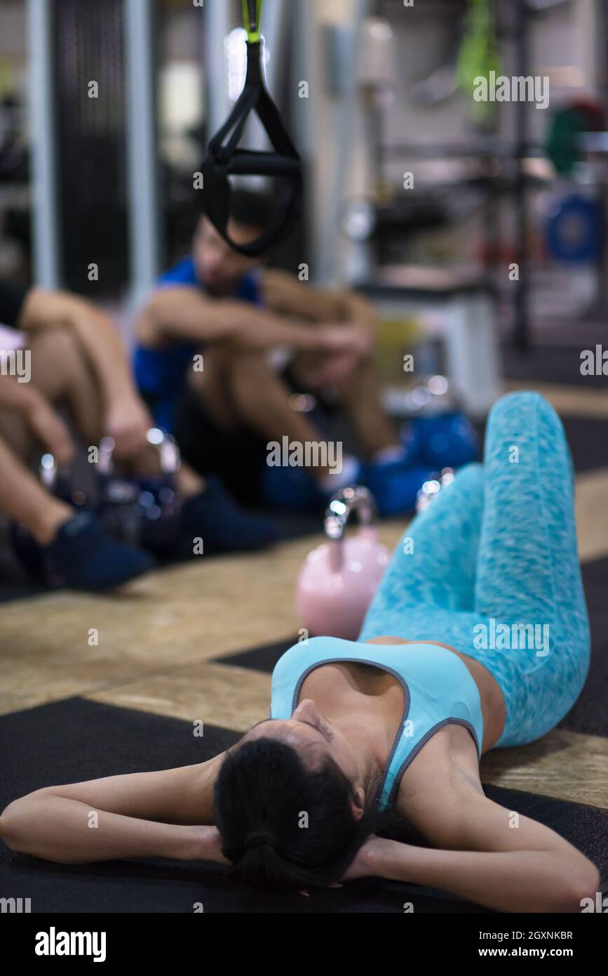 young athlete woman lying on the floor and relaxing before a hard ...