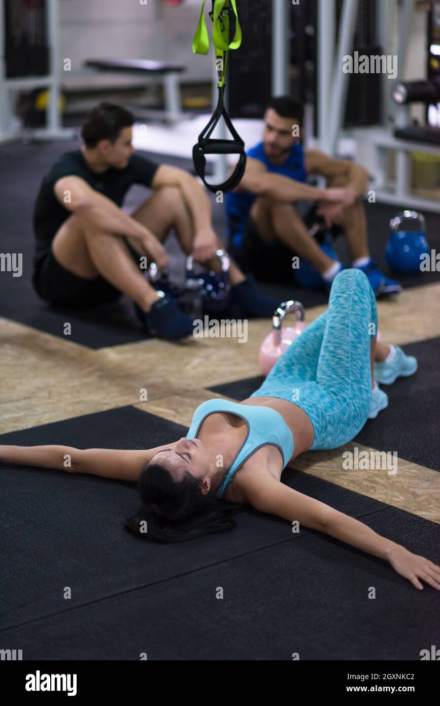young athlete woman lying on the floor and relaxing before a hard ...