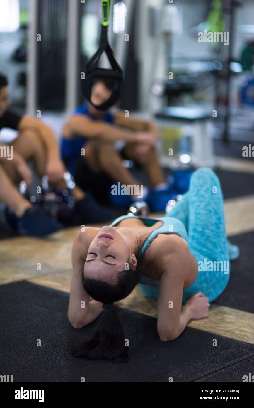 young athlete woman lying on the floor and relaxing before a hard ...