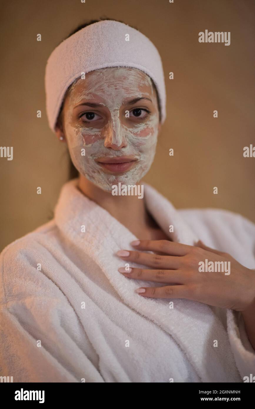 Spa Woman applying Facial Mask Beauty Treatments Close up portrait of ...