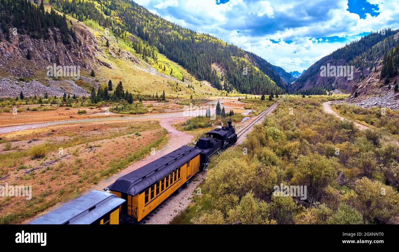 Train though valley in the mountains along river Stock Photo - Alamy