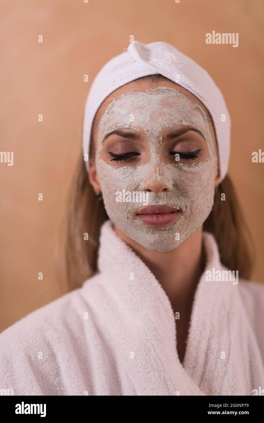 Spa Woman applying Facial Mask Beauty Treatments Close up portrait of ...