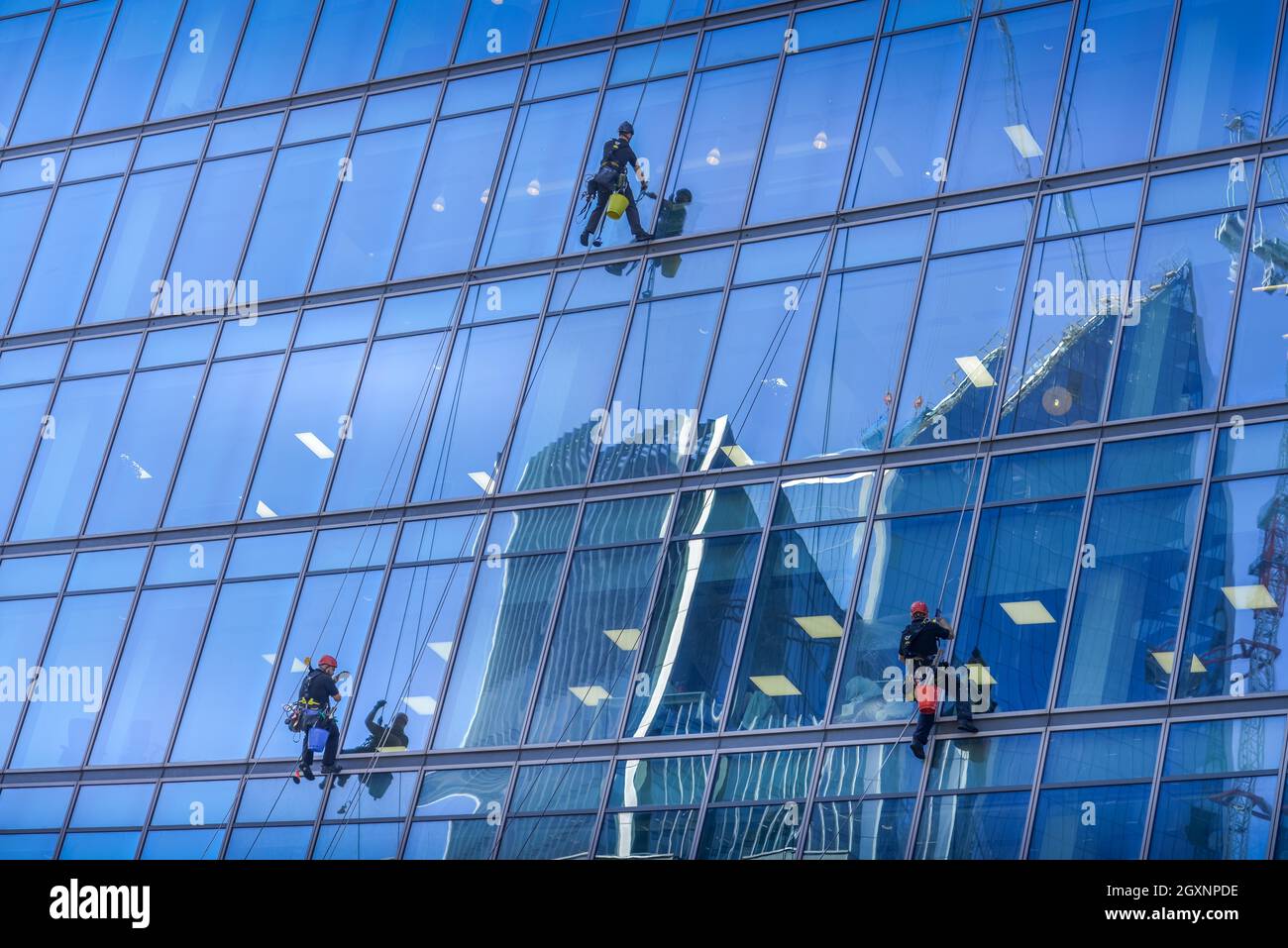 Window cleaner, high-rise building, Financial District, London, England ...