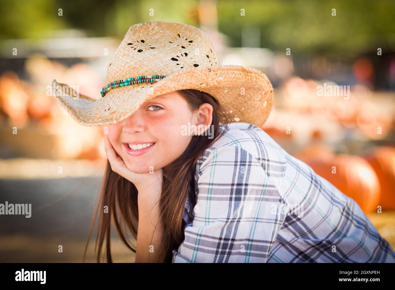Pretty Preteen Girl Wearing Cowboy Hat Portrait at the Pumpkin Patch in ...