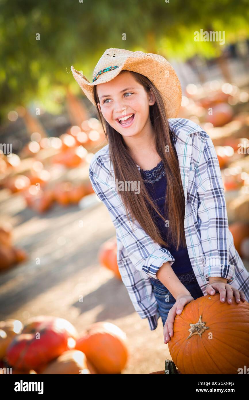 Preteen Girl Wearing Cowboy Hat Playing with a Wheelbarrow at the ...