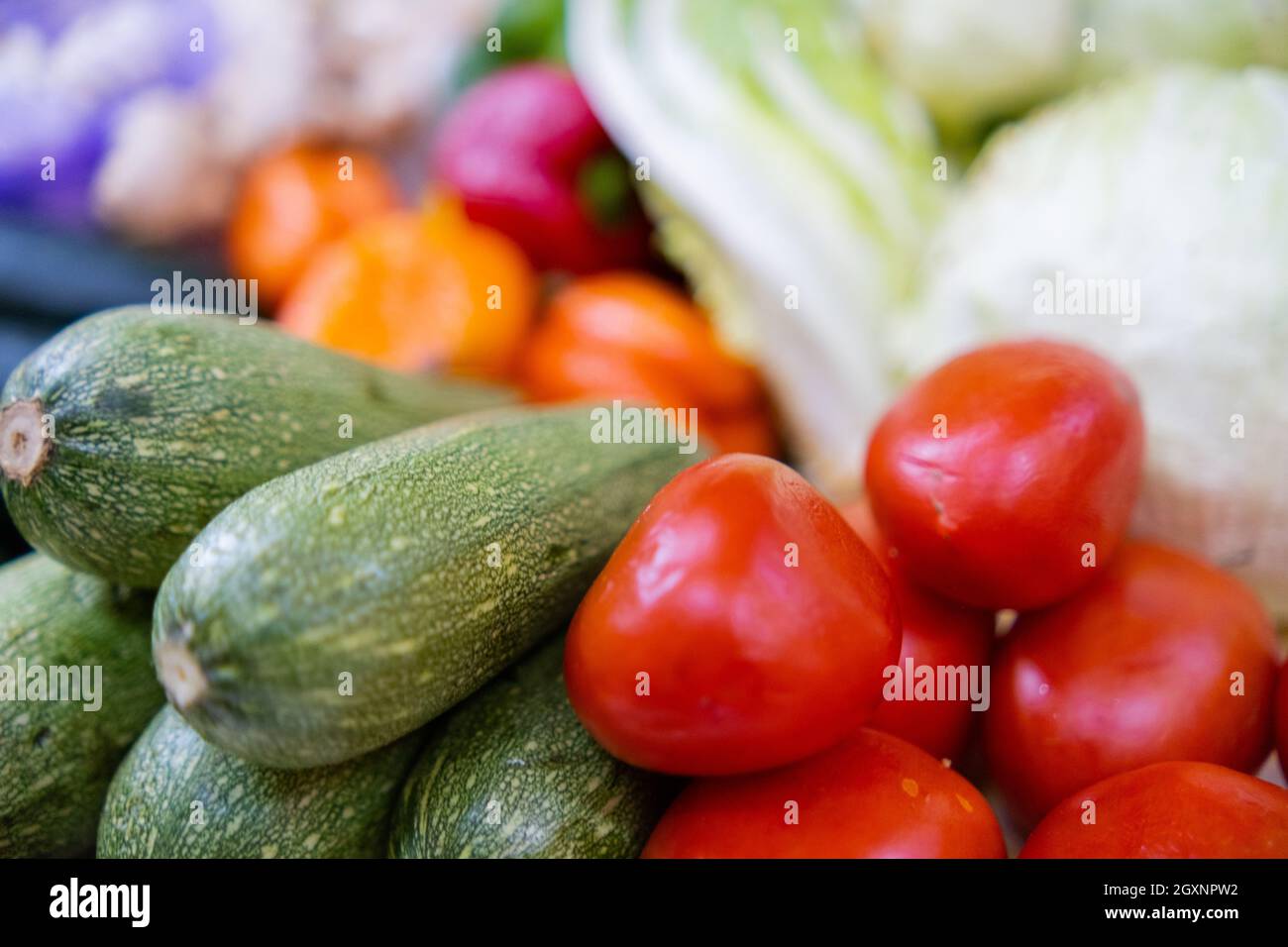 Close-up of colorful vegetable stand with tomatoes, zucchini, bell ...