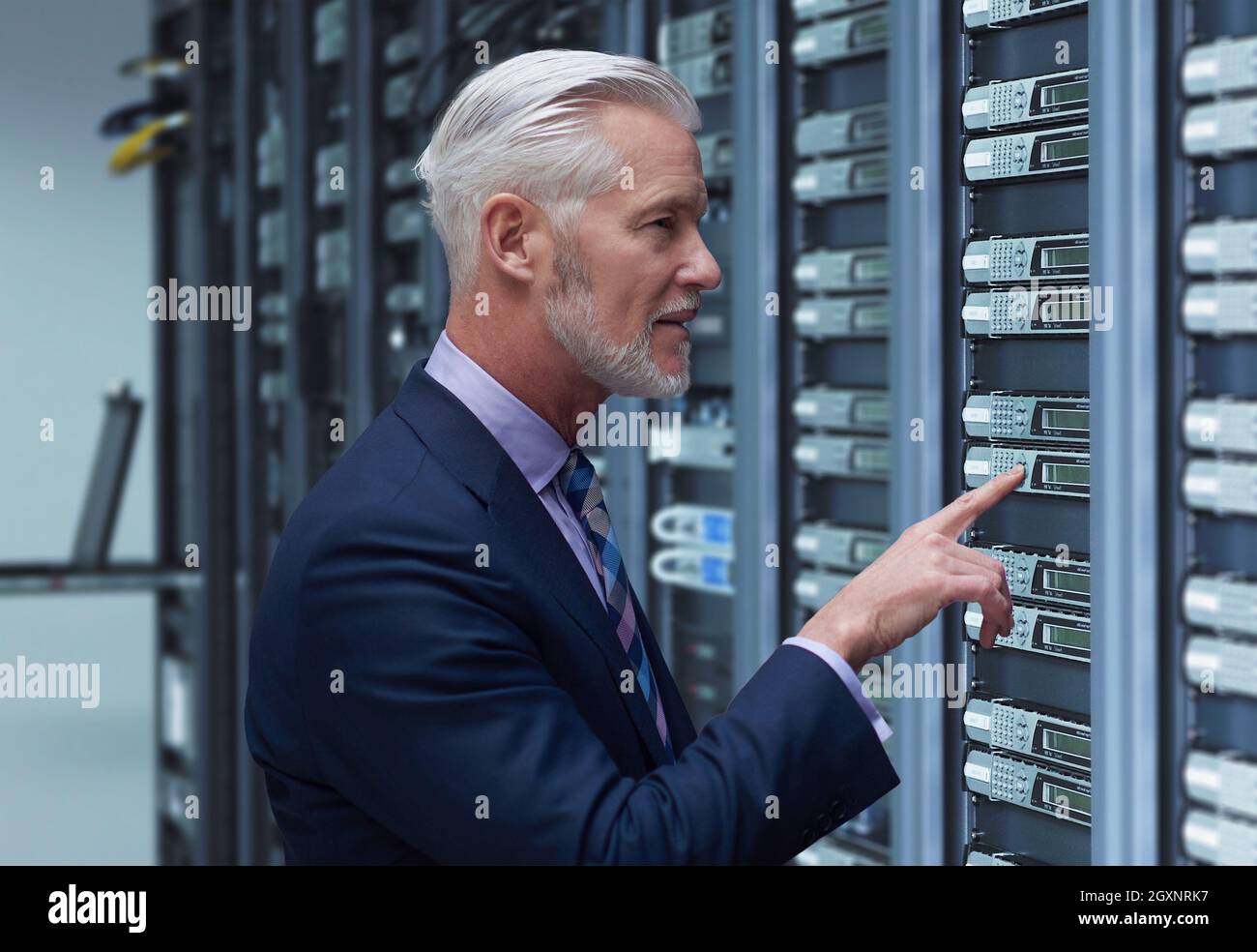 Portrait of senior businessman working in big rack server room Stock ...