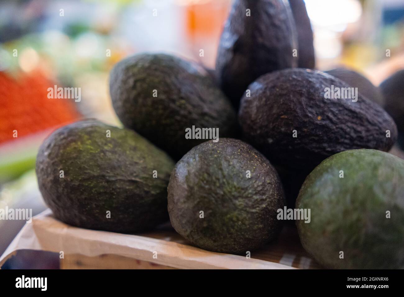 Close-up of pile of fresh avocados with blurry background. Classic ...