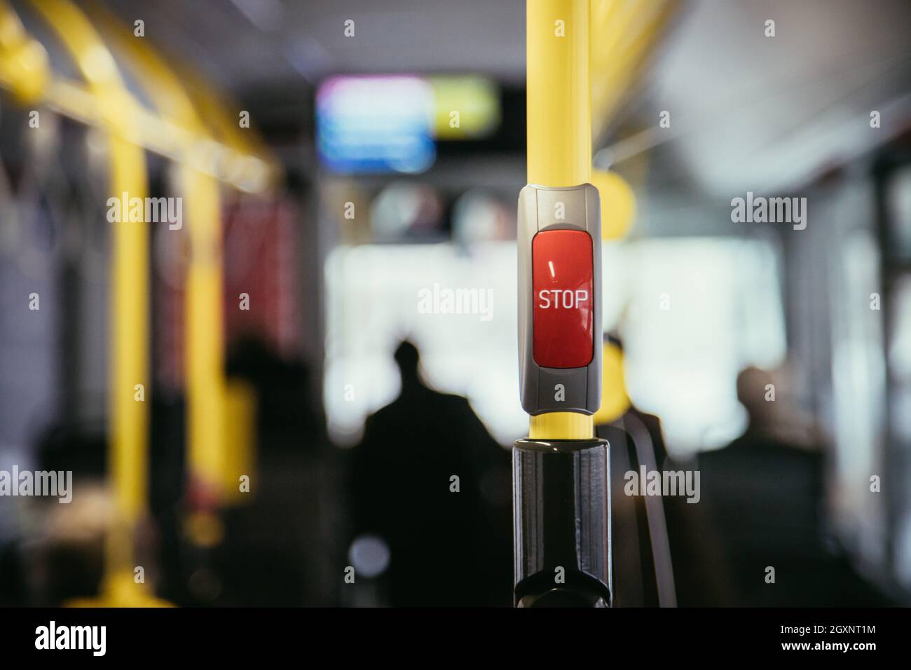 Stop Button in a bus, public transport, blurry Stock Photo - Alamy