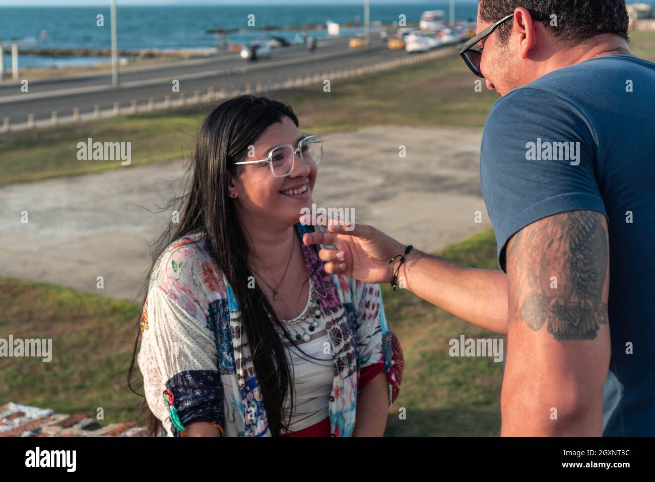 Couple hanging out while outdoors Stock Photo - Alamy