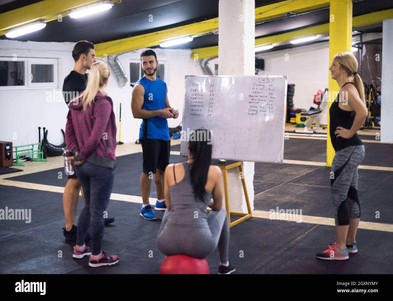 Training course.group of young athletes getting instructions from ...