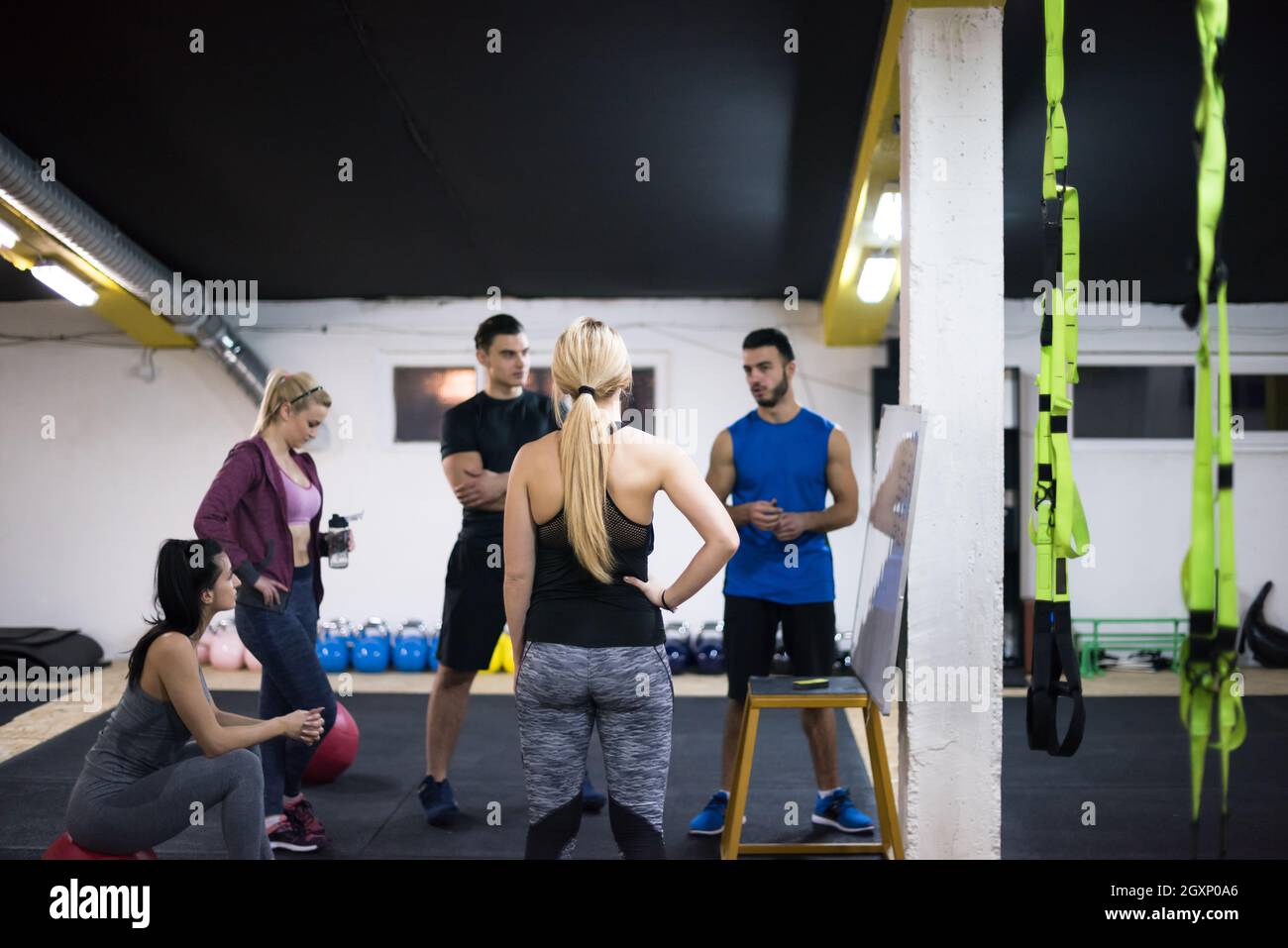 Training course.group of young athletes getting instructions from ...