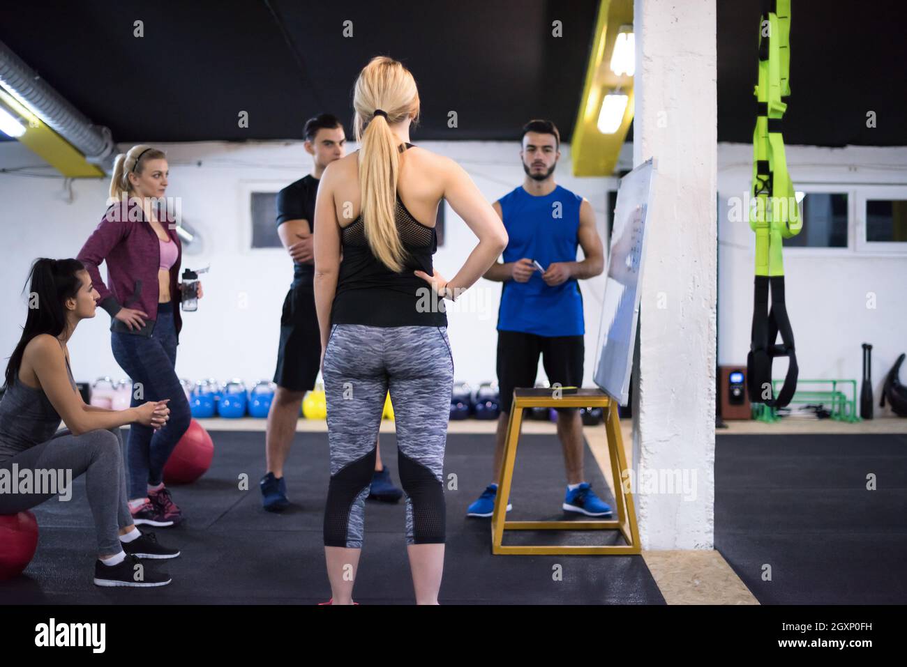 Training course.group of young athletes getting instructions from ...