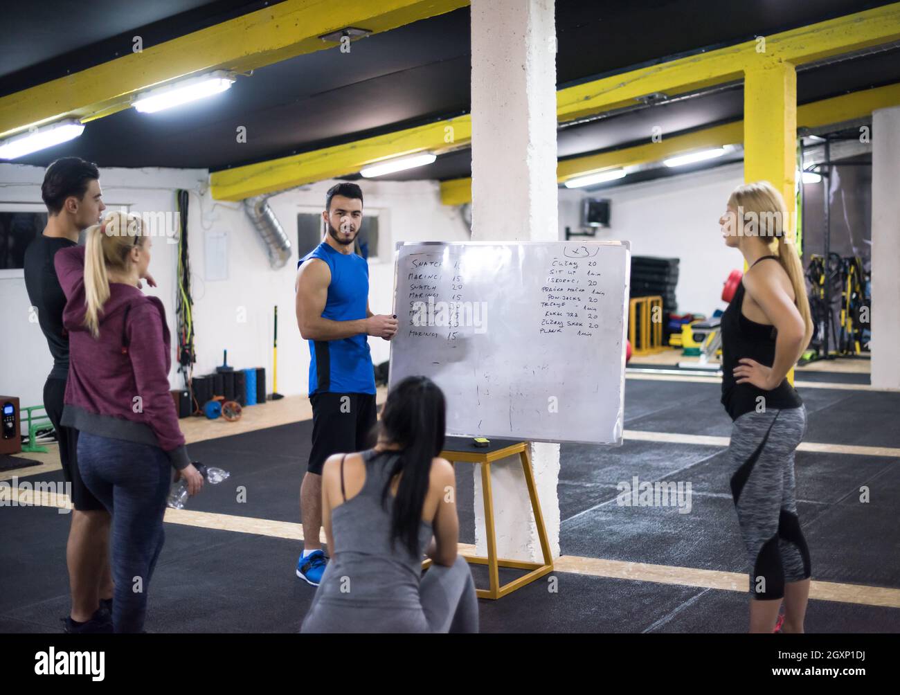 Training course.group of young athletes getting instructions from ...