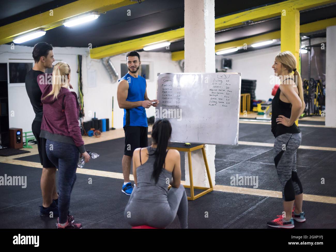 Training course.group of young athletes getting instructions from ...