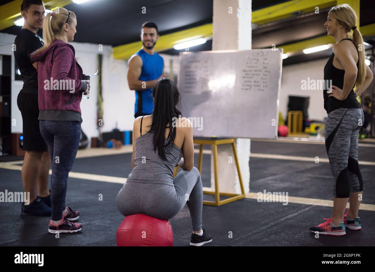 Training course.group of young athletes getting instructions from ...