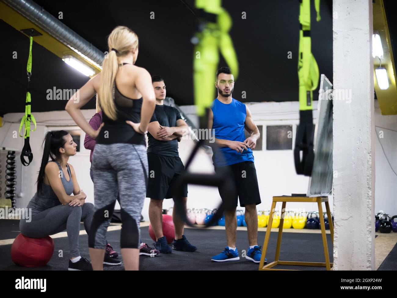 Training course.group of young athletes getting instructions from ...