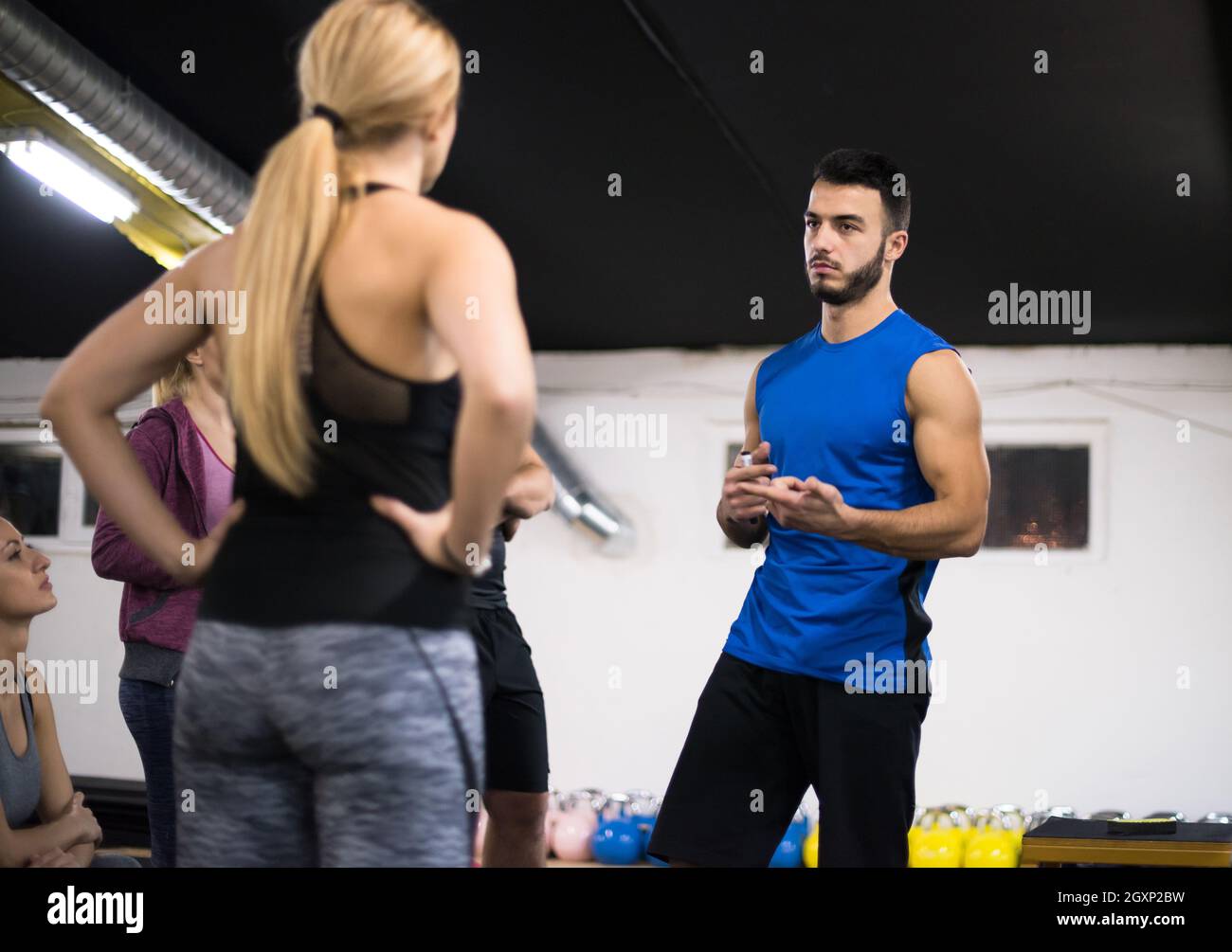 Training course.group of young athletes getting instructions from ...