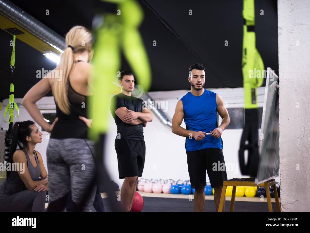 Training course.group of young athletes getting instructions from ...