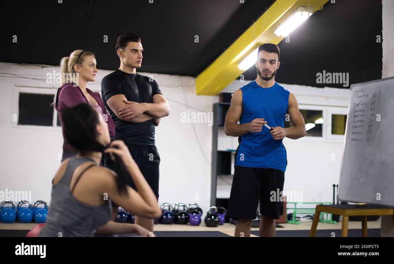 Training course.group of young athletes getting instructions from ...