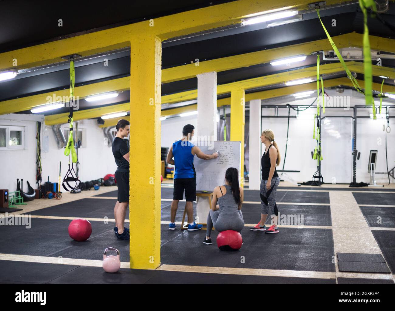 Training course.group of young athletes getting instructions from ...