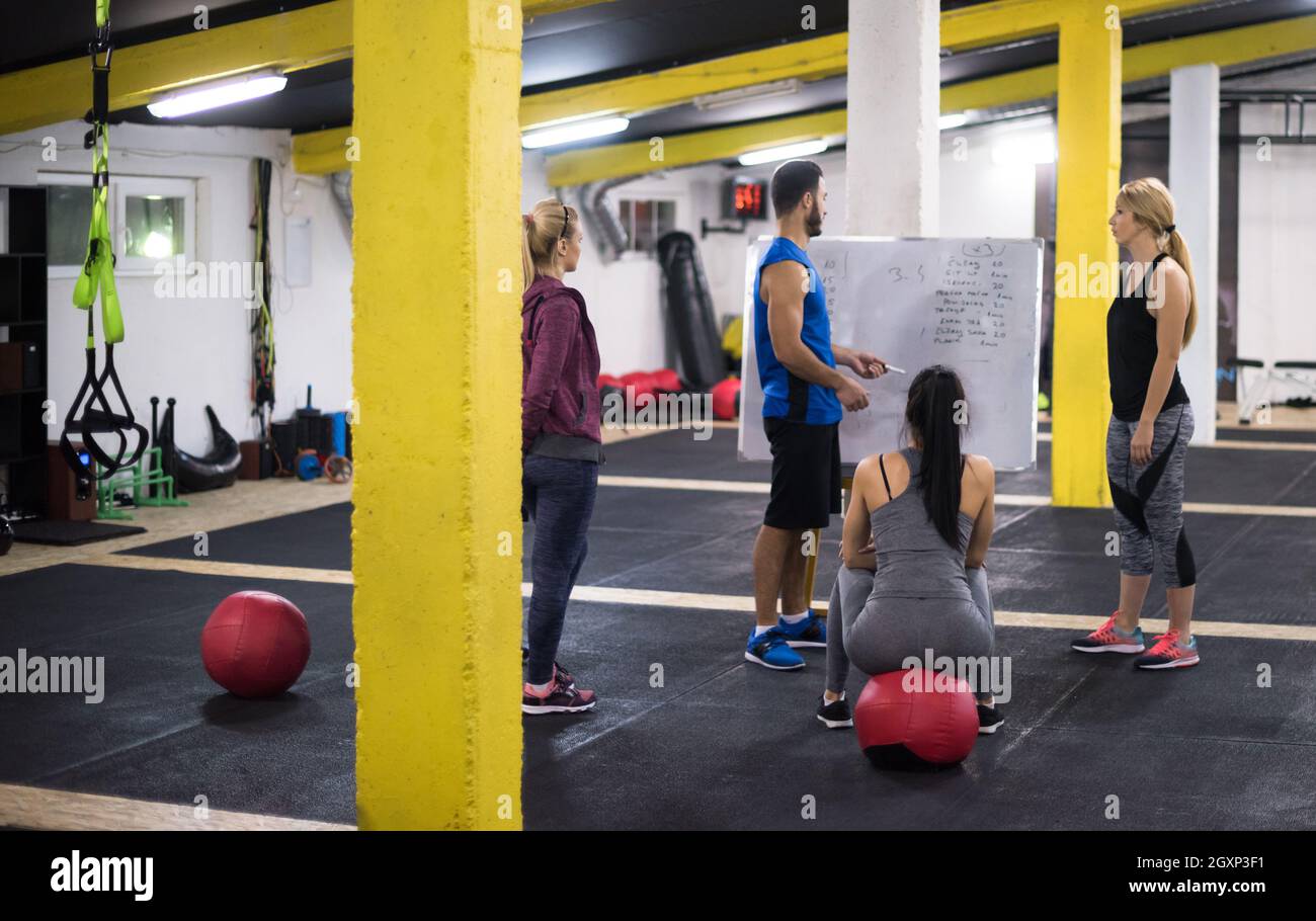 Training course.group of young athletes getting instructions from ...