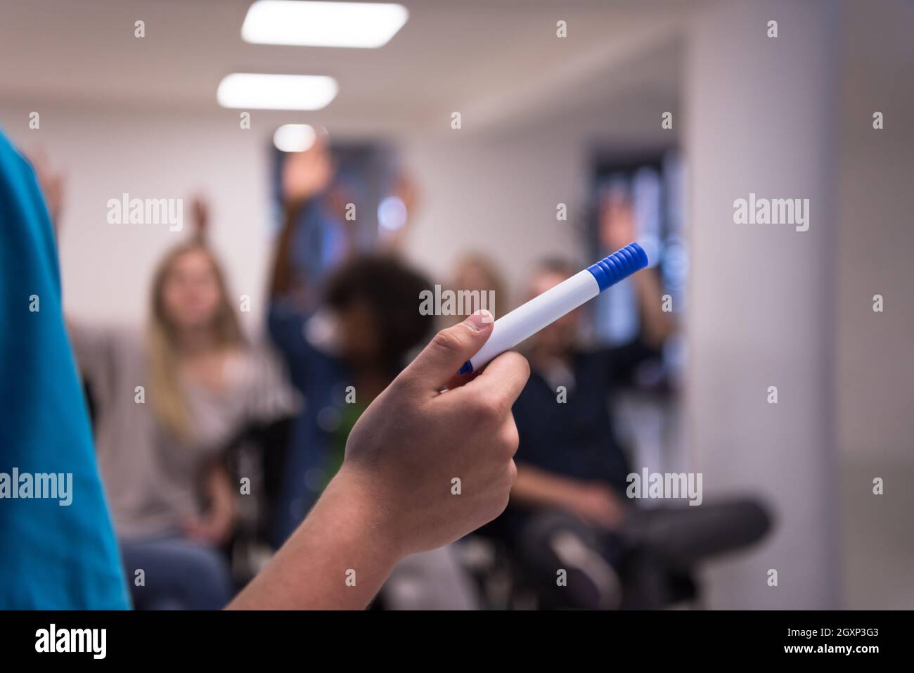 close up of teacher hand with marker while teaching lessons in school ...
