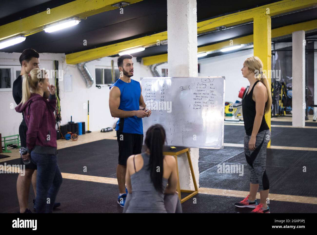 Training course.group of young athletes getting instructions from ...