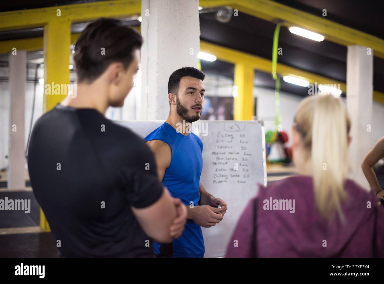 Training course.group of young athletes getting instructions from ...