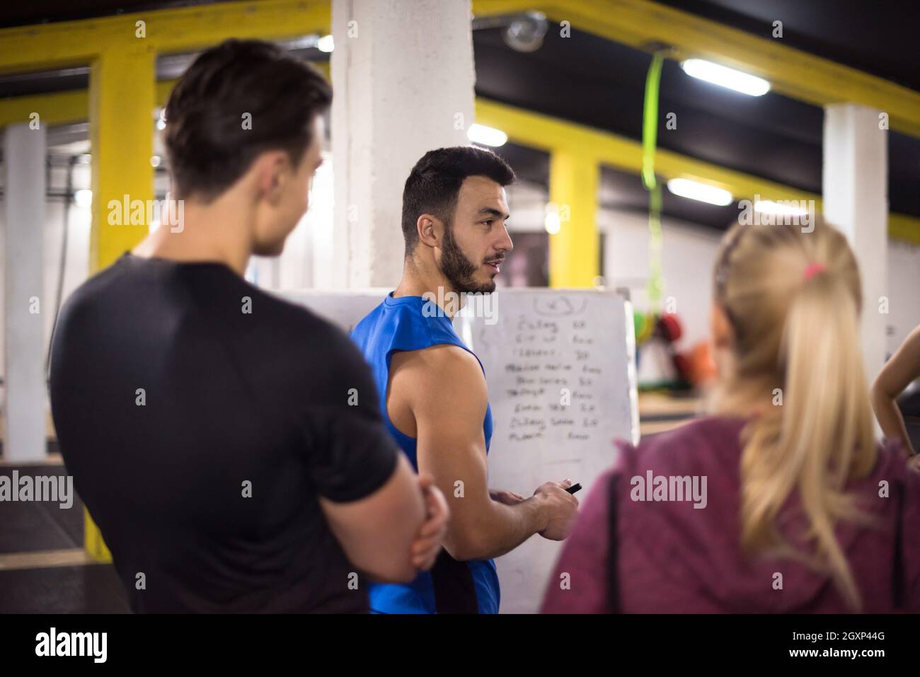 Training course.group of young athletes getting instructions from ...