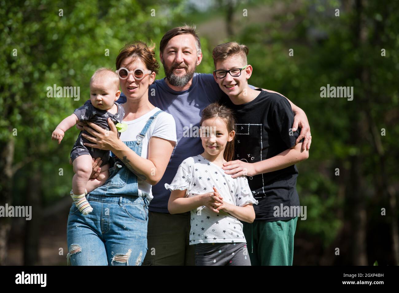 portrait of happy young big hipster family while having picninc and fun ...