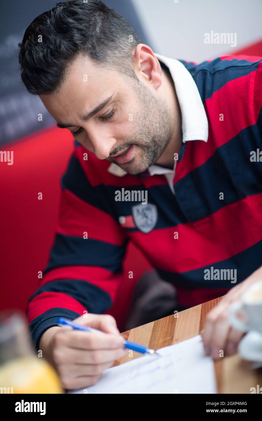 designer with a pen, designing and sketching his idea for a furniture ...