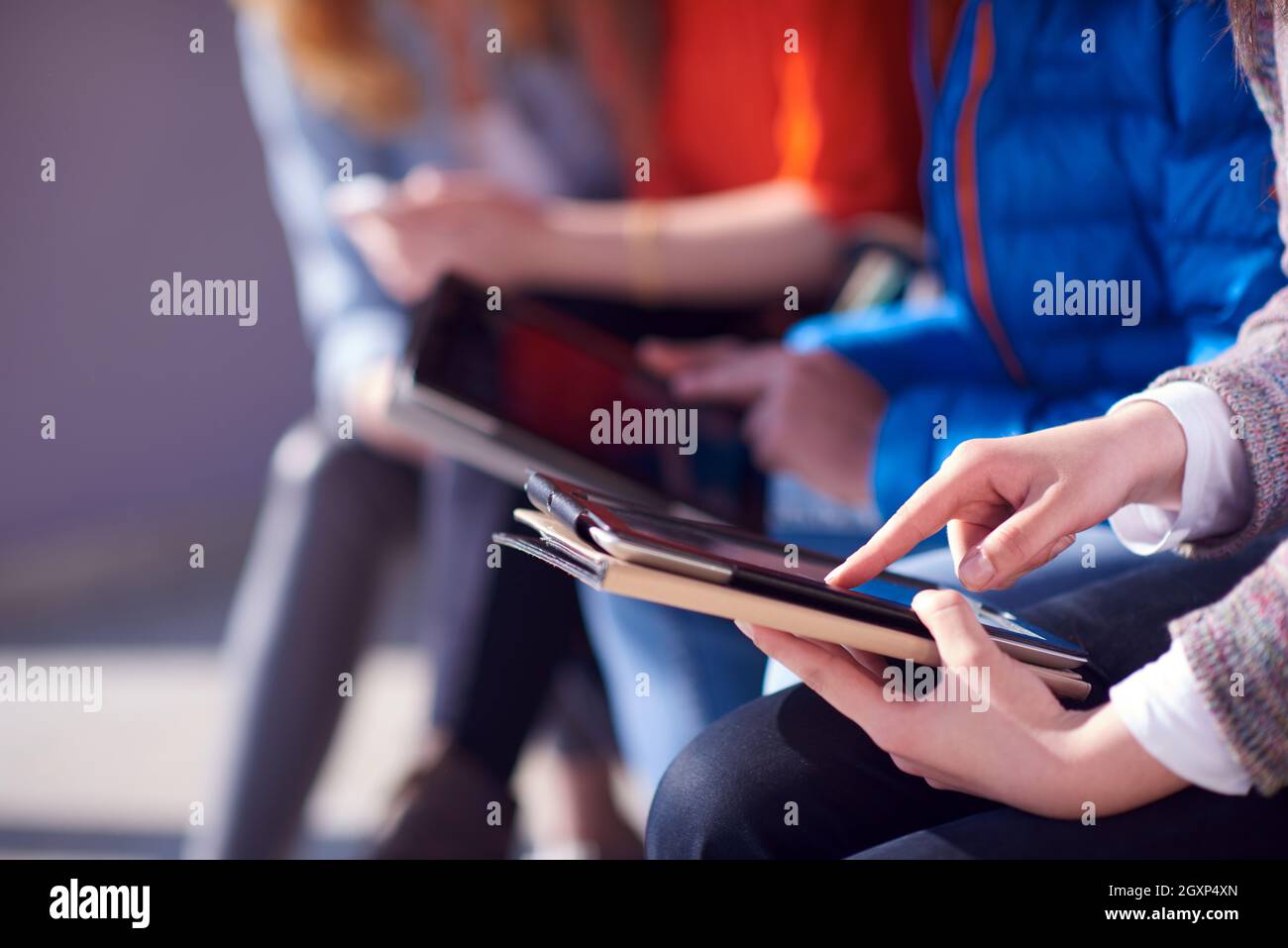 students group working on school project together on tablet computer at ...