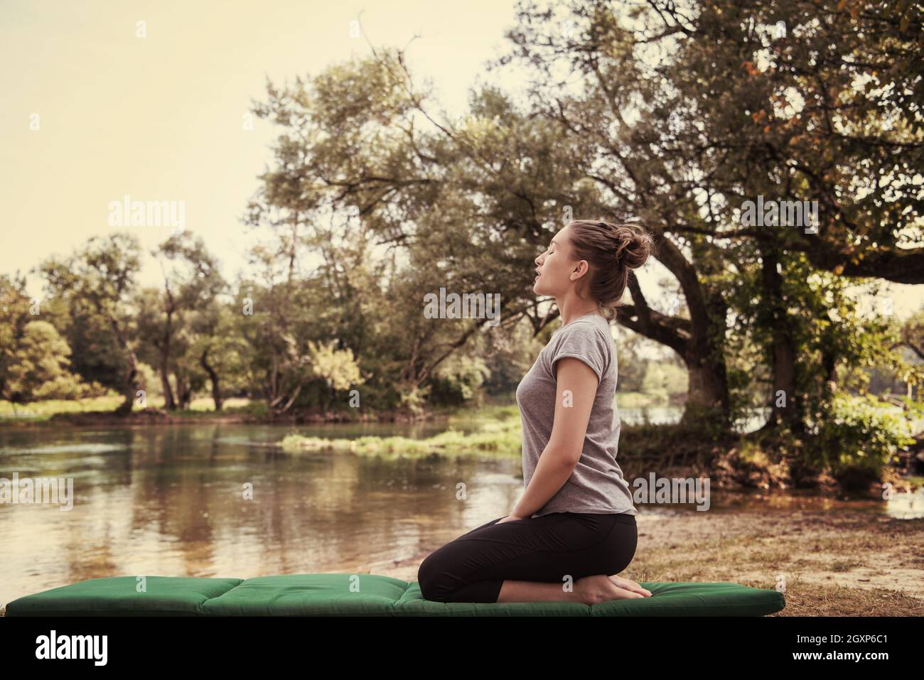 healthy woman relaxing while meditating and doing yoga exercise in the ...