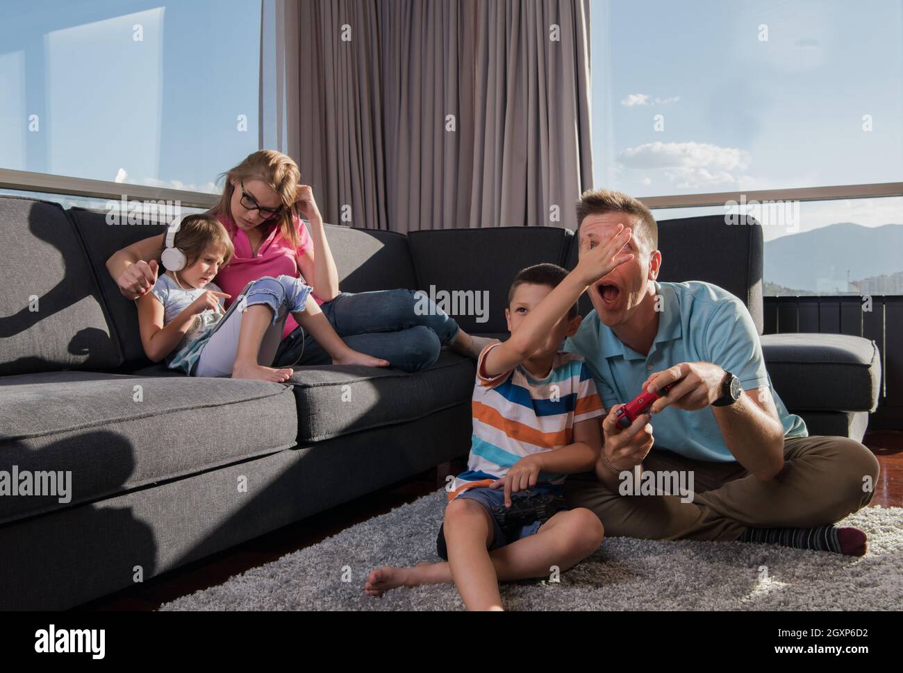 Happy family. Father, mother and children playing a video game Father ...