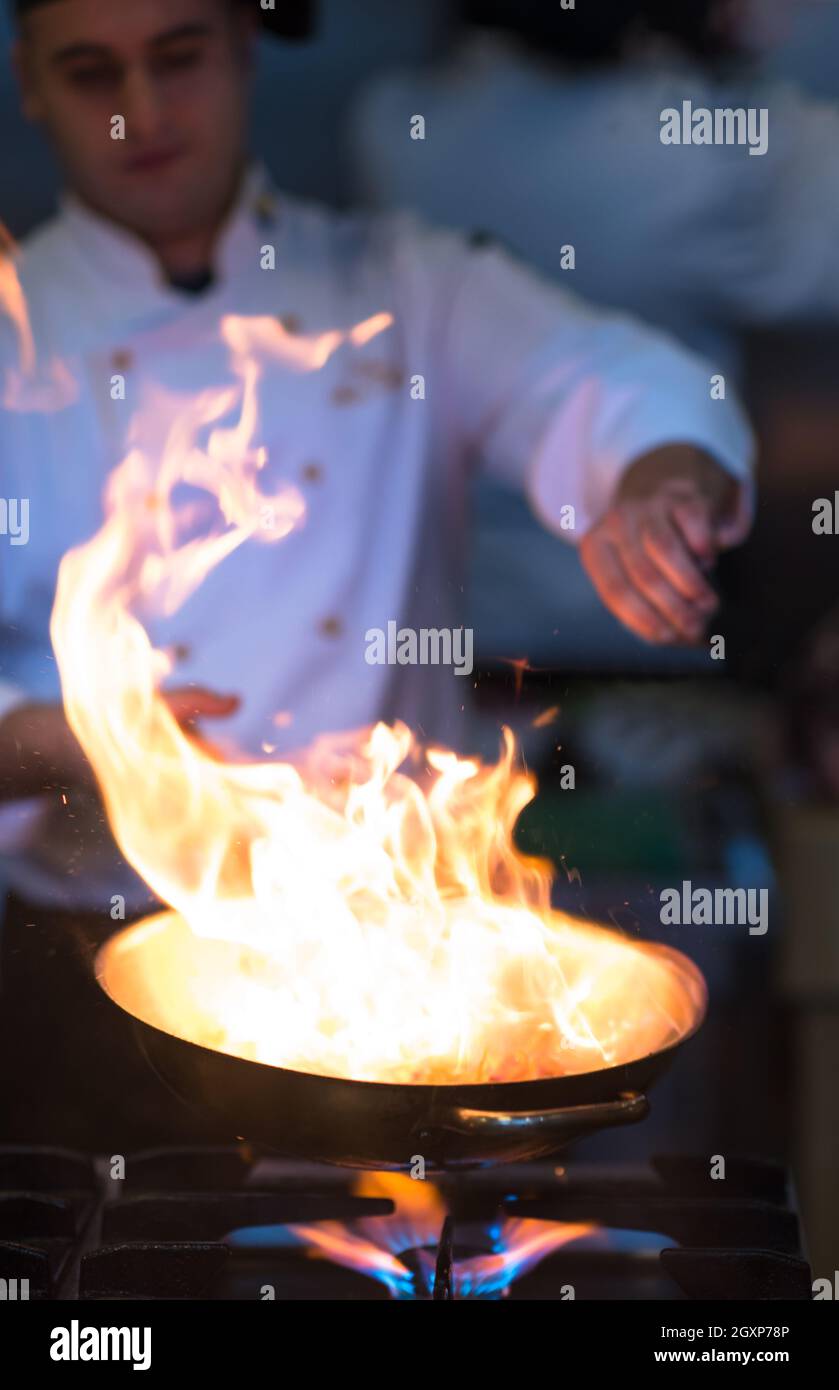 Cook working flaming pan hi-res stock photography and images - Alamy
