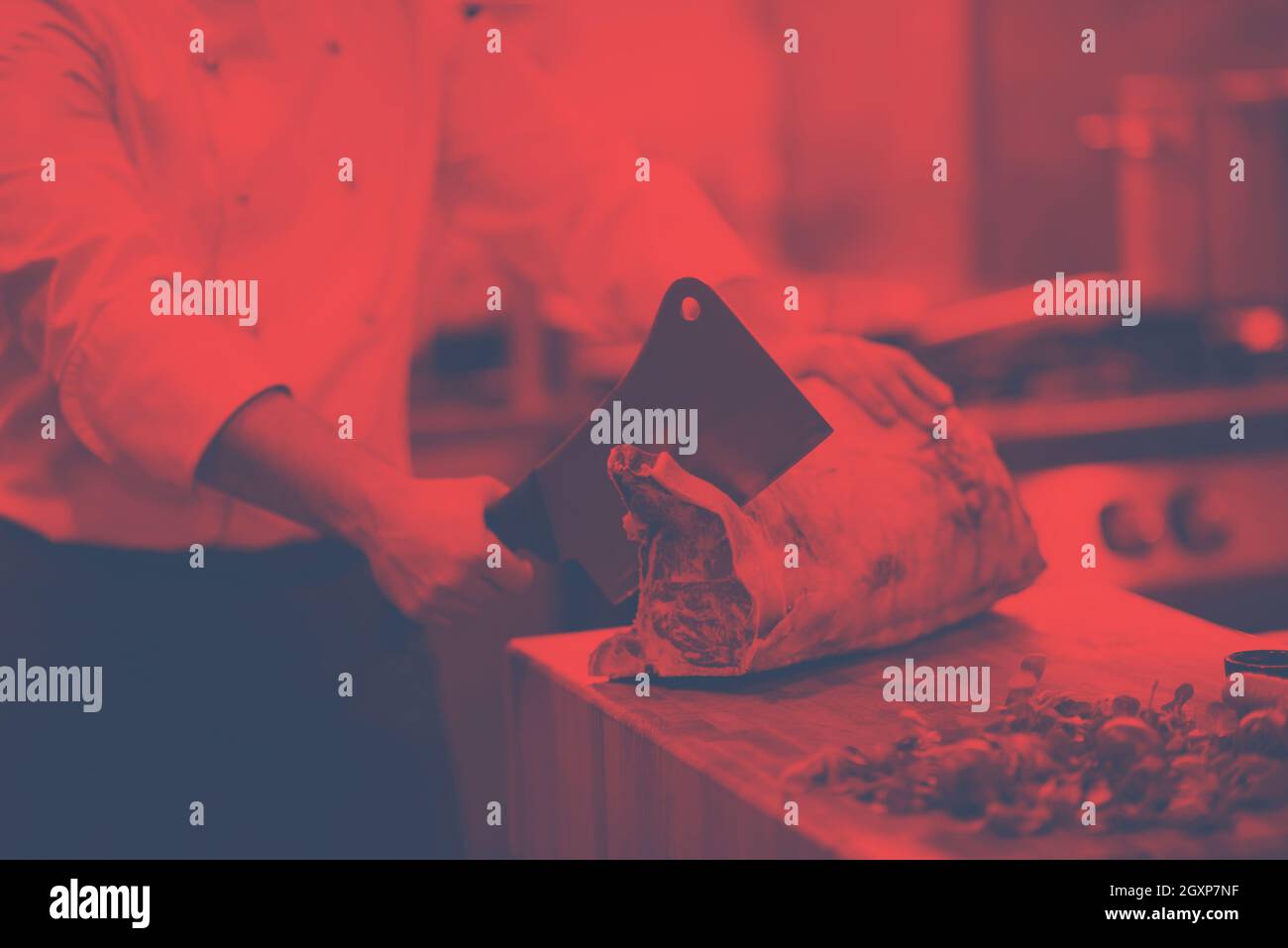 chef using ax while cutting big piece of beef on wooden board in ...