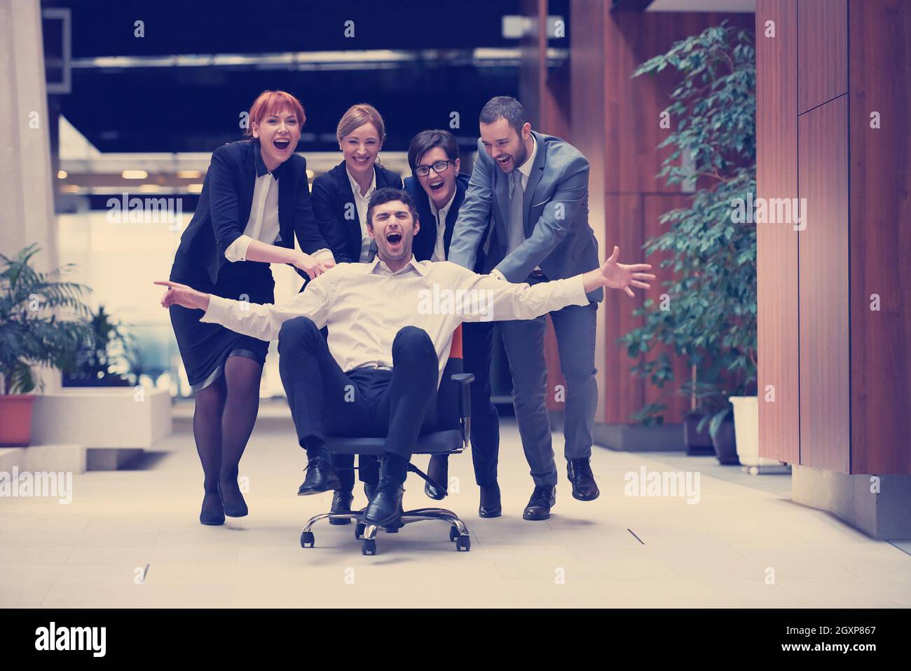 business people group at modern office indoors have fun and push office ...